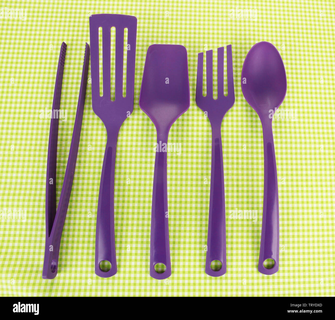 Plastic kitchen utensils on fabric background Stock Photo - Alamy