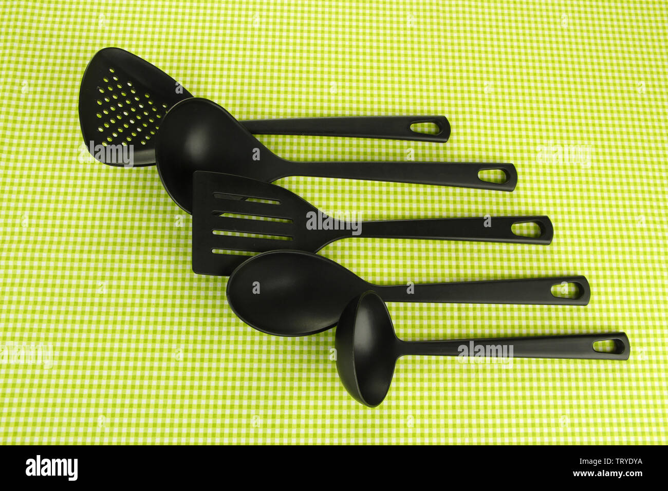 Plastic kitchen utensils on fabric background Stock Photo - Alamy
