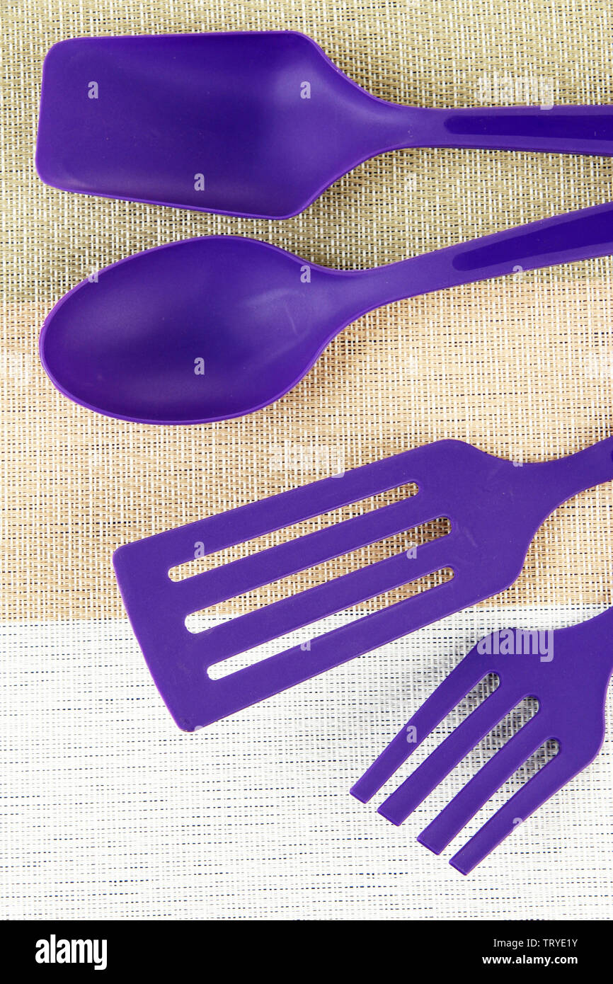 Plastic kitchen utensils on fabric background Stock Photo - Alamy