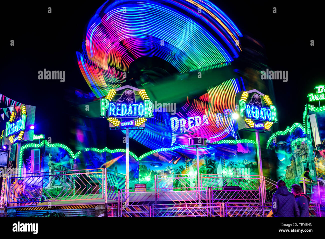 Colorful illuminated, spectacular fairground attractions on funfair in ...