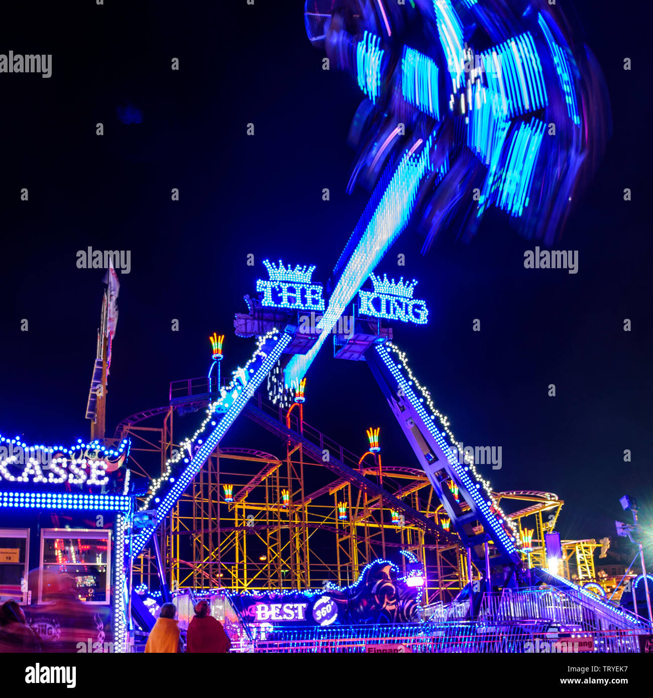 Colorful illuminated, spectacular fairground attractions on funfair in ...