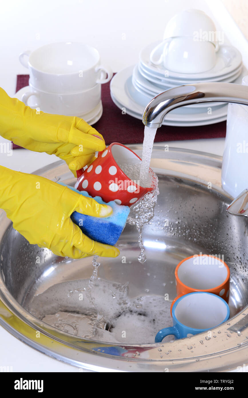 Close up hands of woman washing dishes in kitchen Stock Photo - Alamy