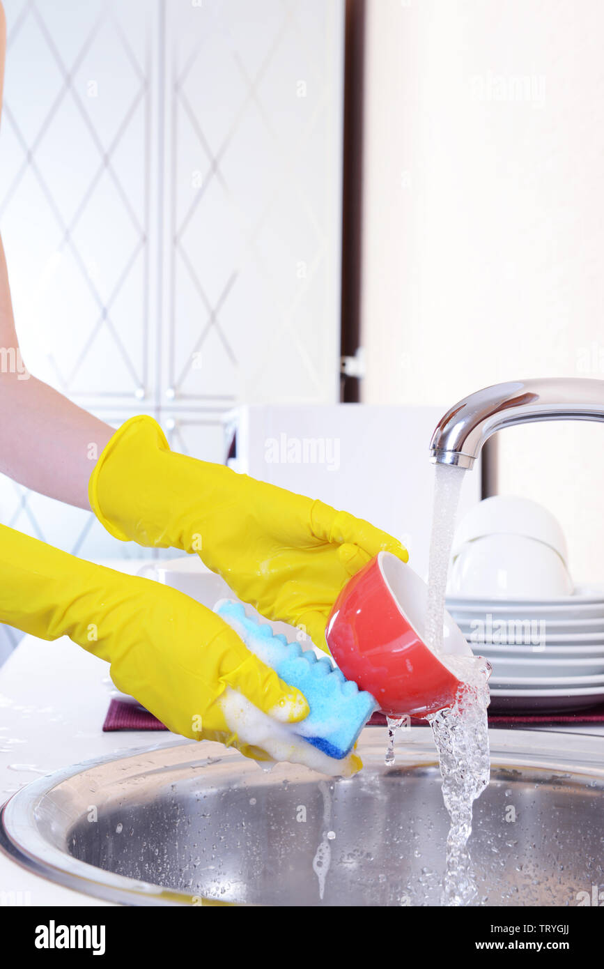 Close up hands of woman washing dishes in kitchen Stock Photo - Alamy