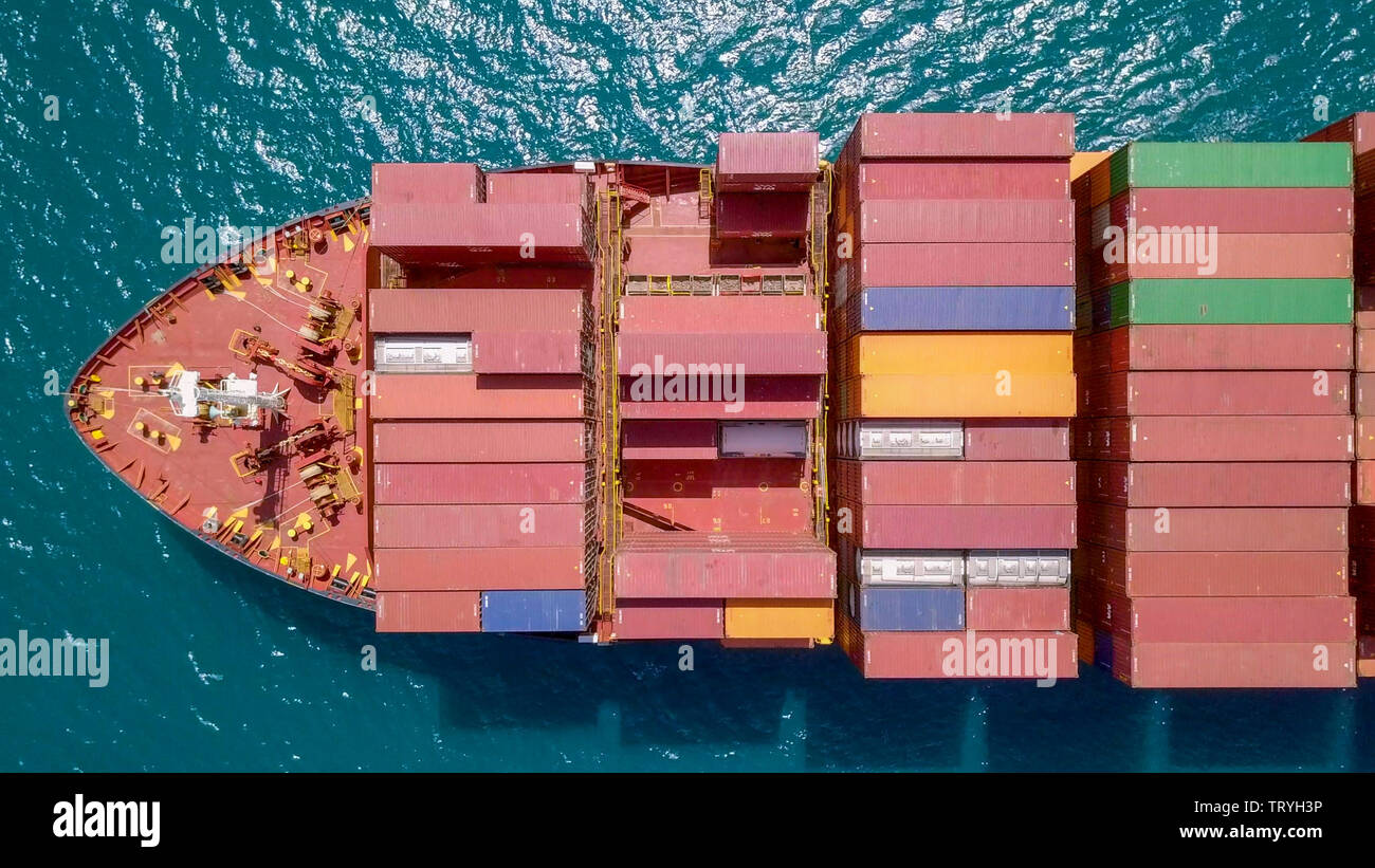 Aerial image of a large container ship at sea, loaded with various ...