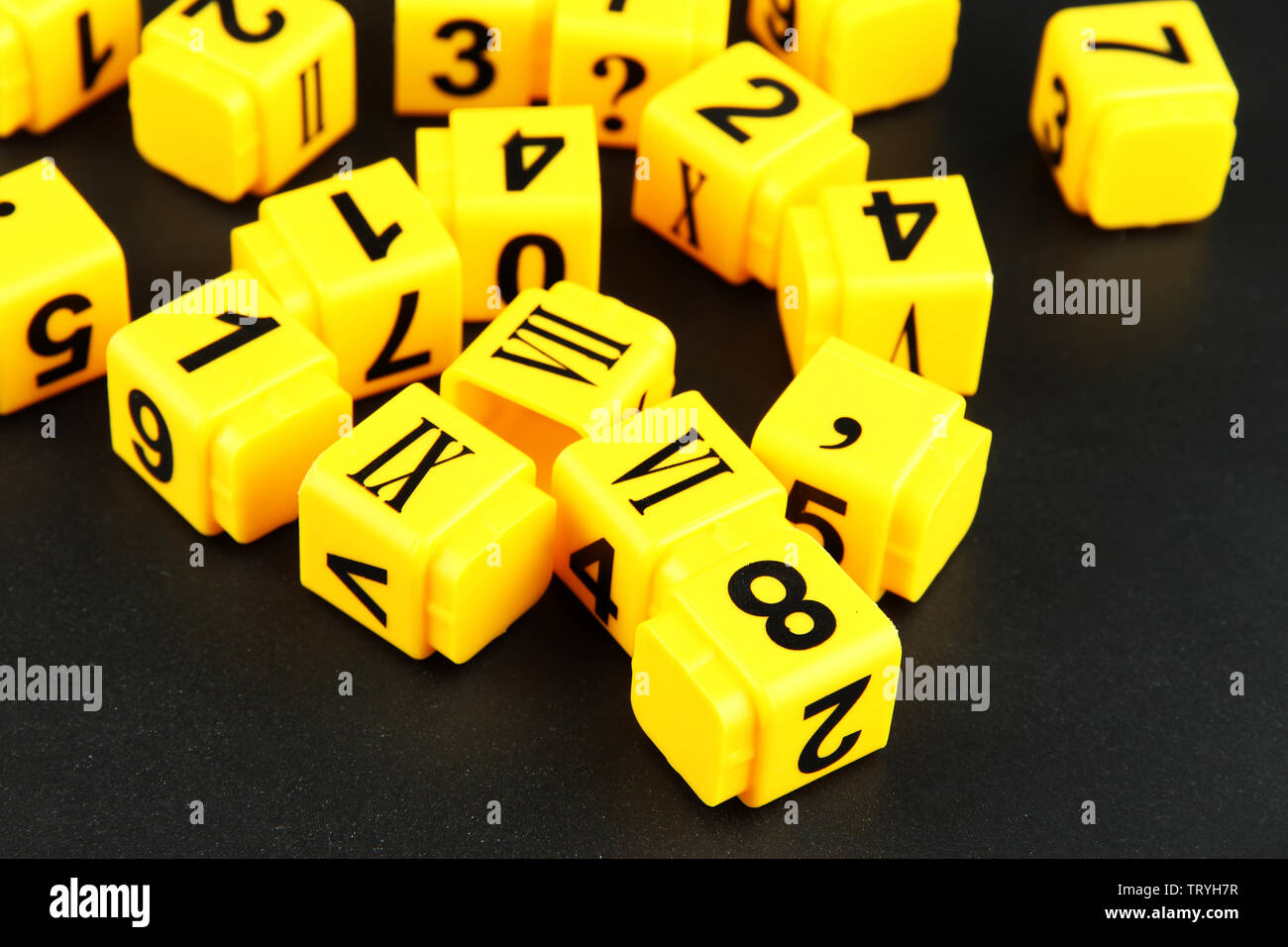 Educational cubes with different numbers on black board Stock Photo - Alamy