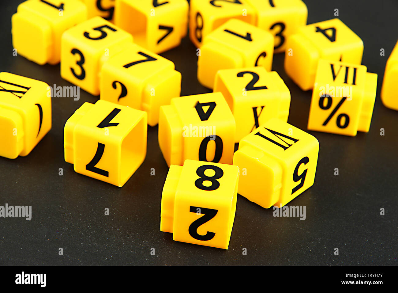 Educational cubes with different numbers on black board Stock Photo - Alamy