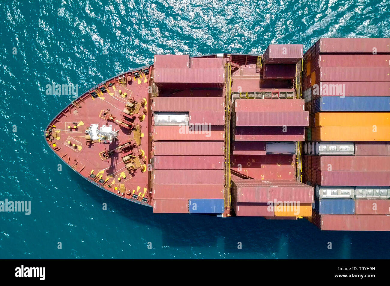 Aerial image of a large container ship at sea, loaded with various ...