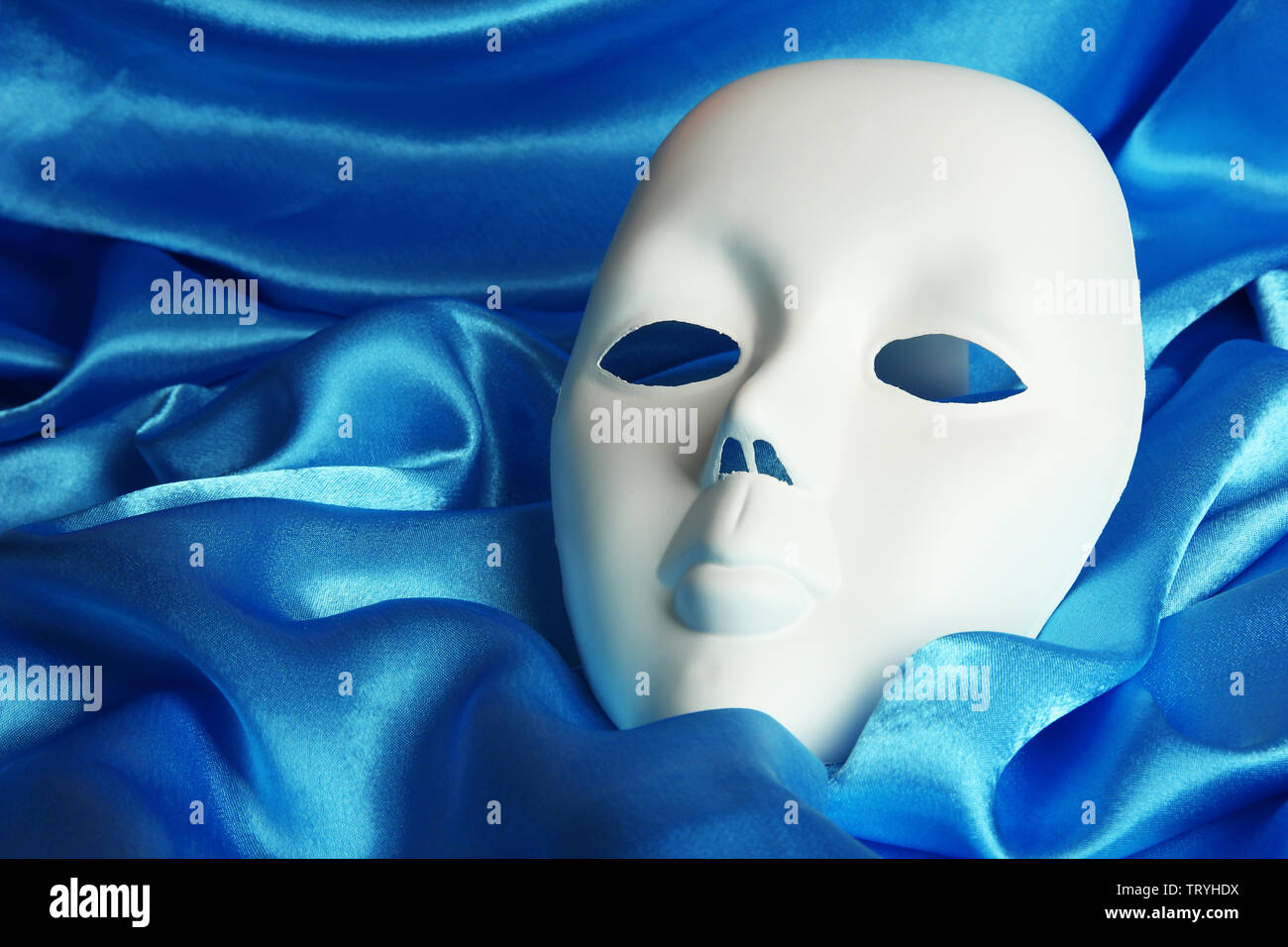 Mask on blue fabric background Stock Photo - Alamy