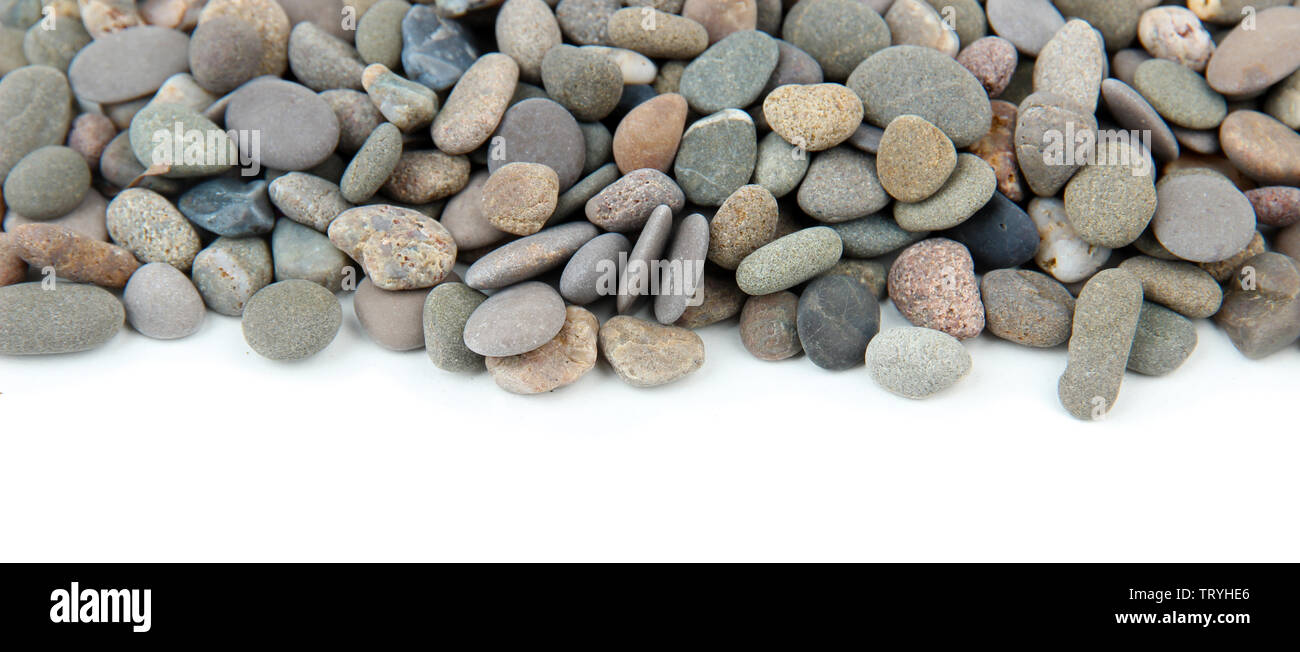 Small sea stones, isolated on white Stock Photo - Alamy