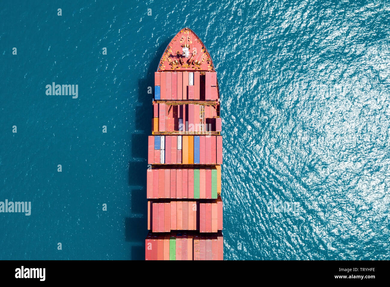 Aerial image of a large container ship at sea, loaded with various ...
