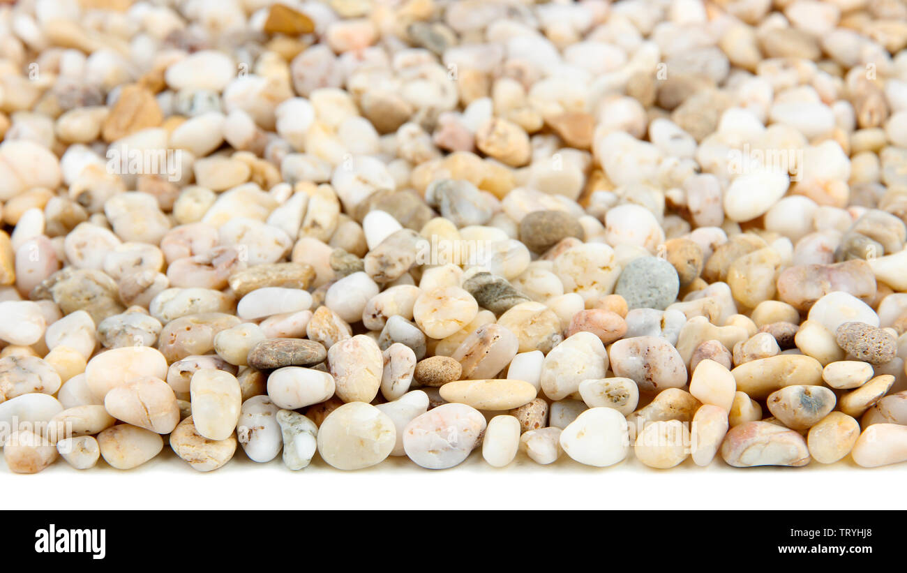 Small sea stones, isolated on white Stock Photo - Alamy