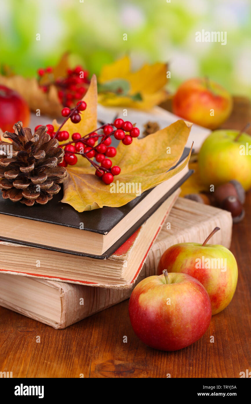Books and autumn leaves on wooden table on natural background Stock ...