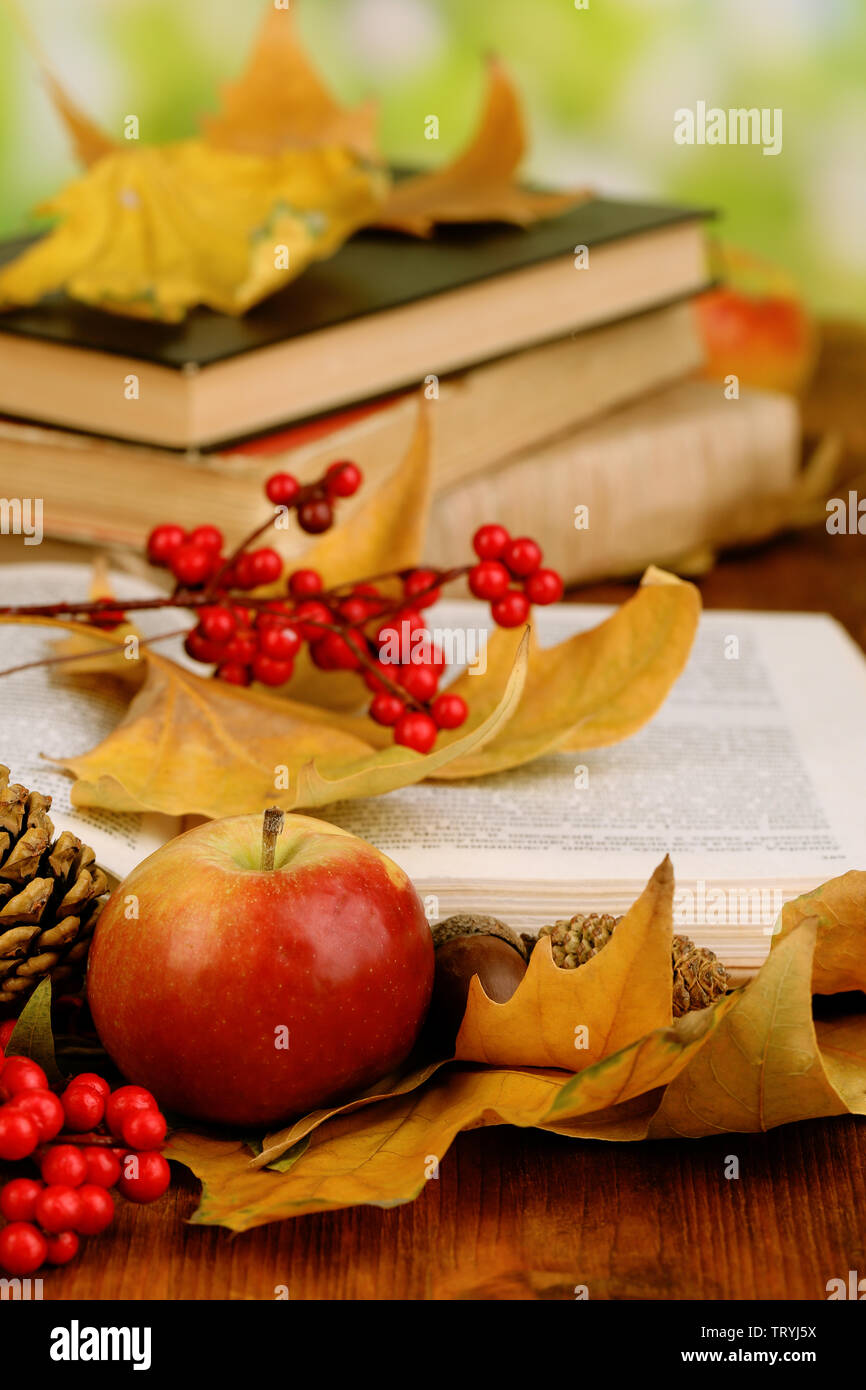 Books and autumn leaves on wooden table on natural background Stock ...