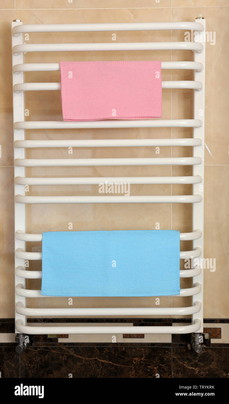 Color towels on radiator in bathroom Stock Photo - Alamy