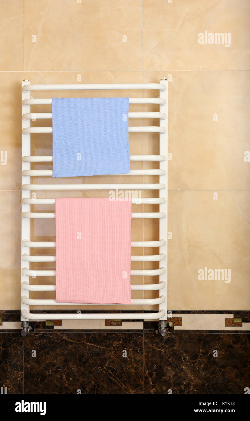 Color towels on radiator in bathroom Stock Photo - Alamy