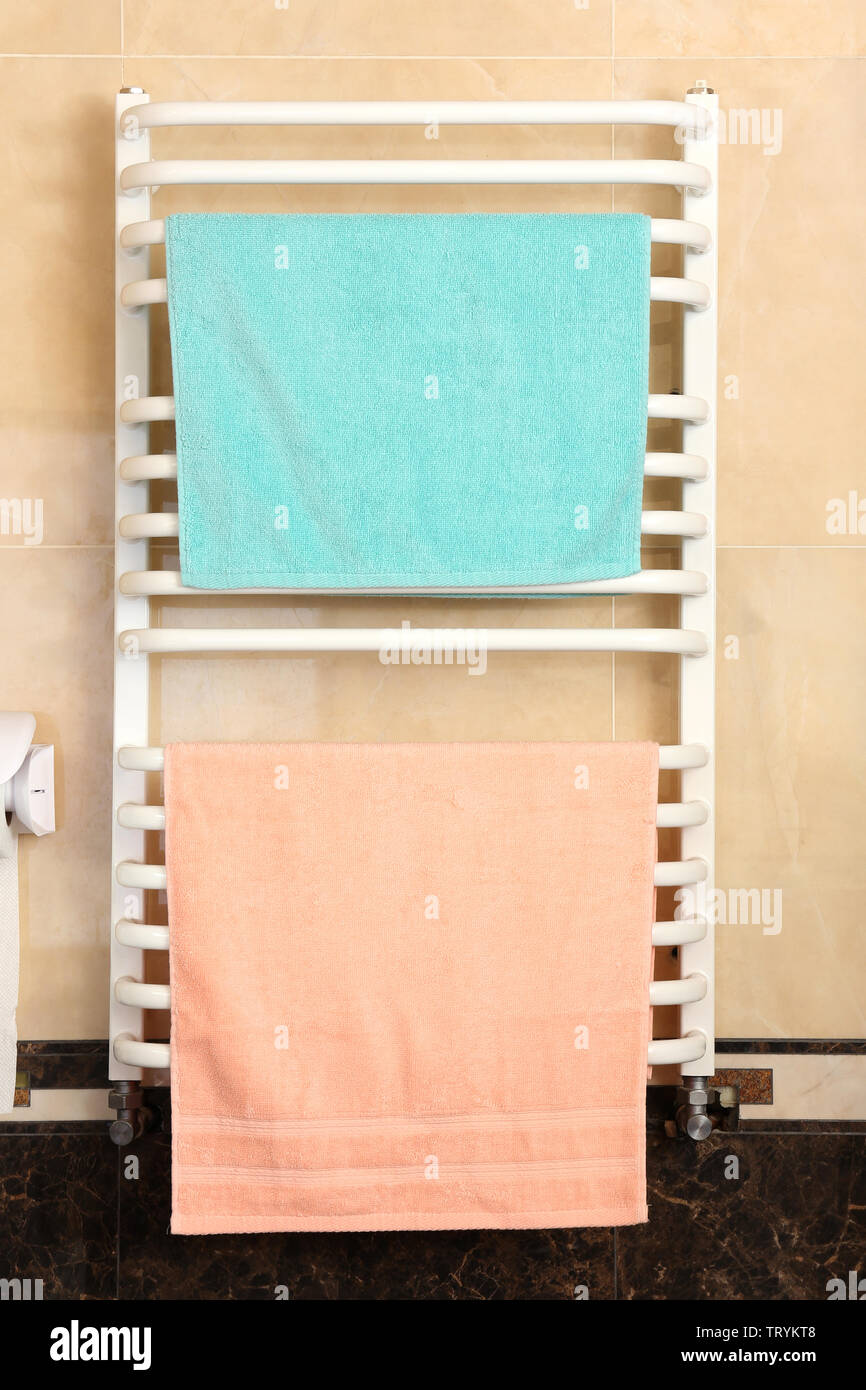 Color towels on radiator in bathroom Stock Photo - Alamy