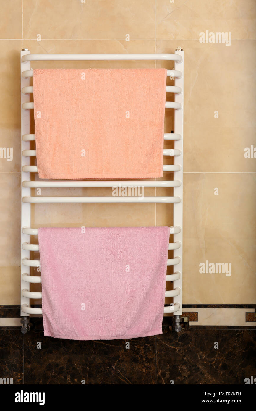 Color towels on radiator in bathroom Stock Photo - Alamy