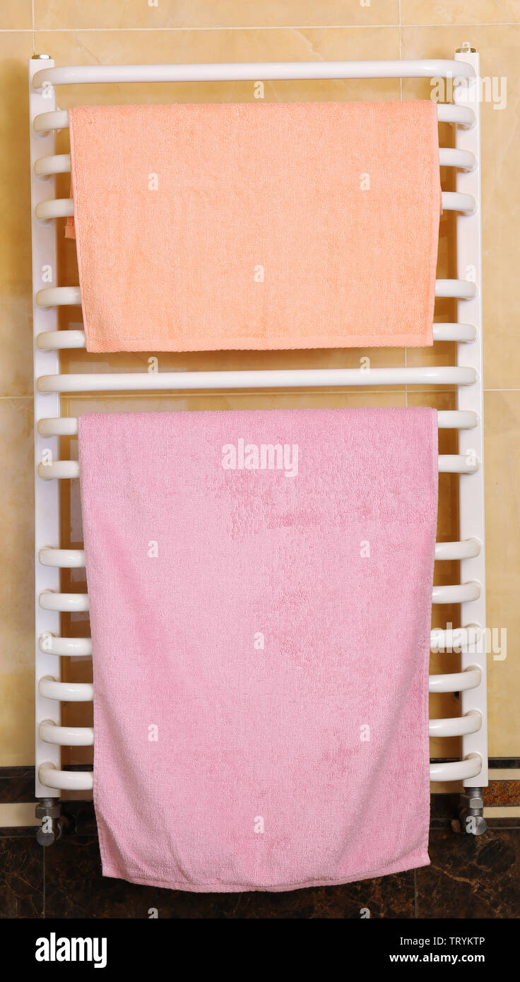 Color towels on radiator in bathroom Stock Photo - Alamy