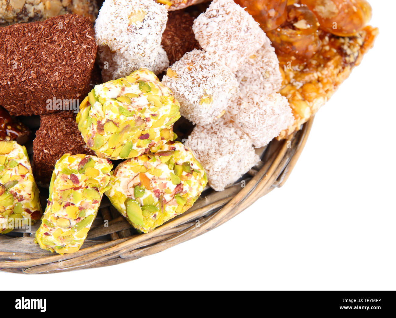 Tasty oriental sweets on wicker tray, isolated on white Stock Photo - Alamy