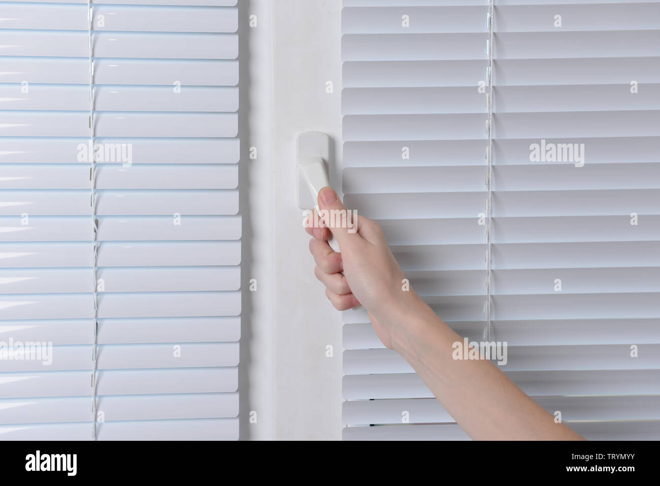 Hand opening window with white jalousie, close up Stock Photo - Alamy