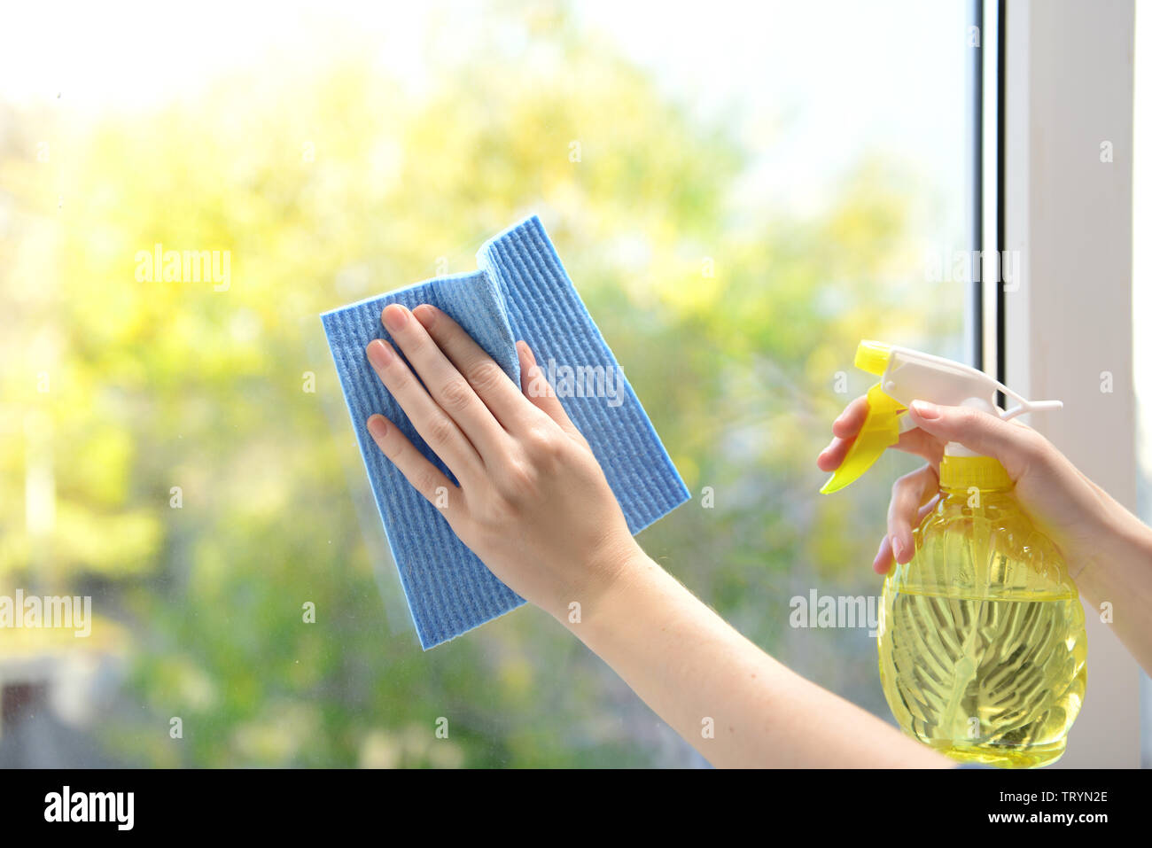 Hands with spray cleaning the window Stock Photo - Alamy
