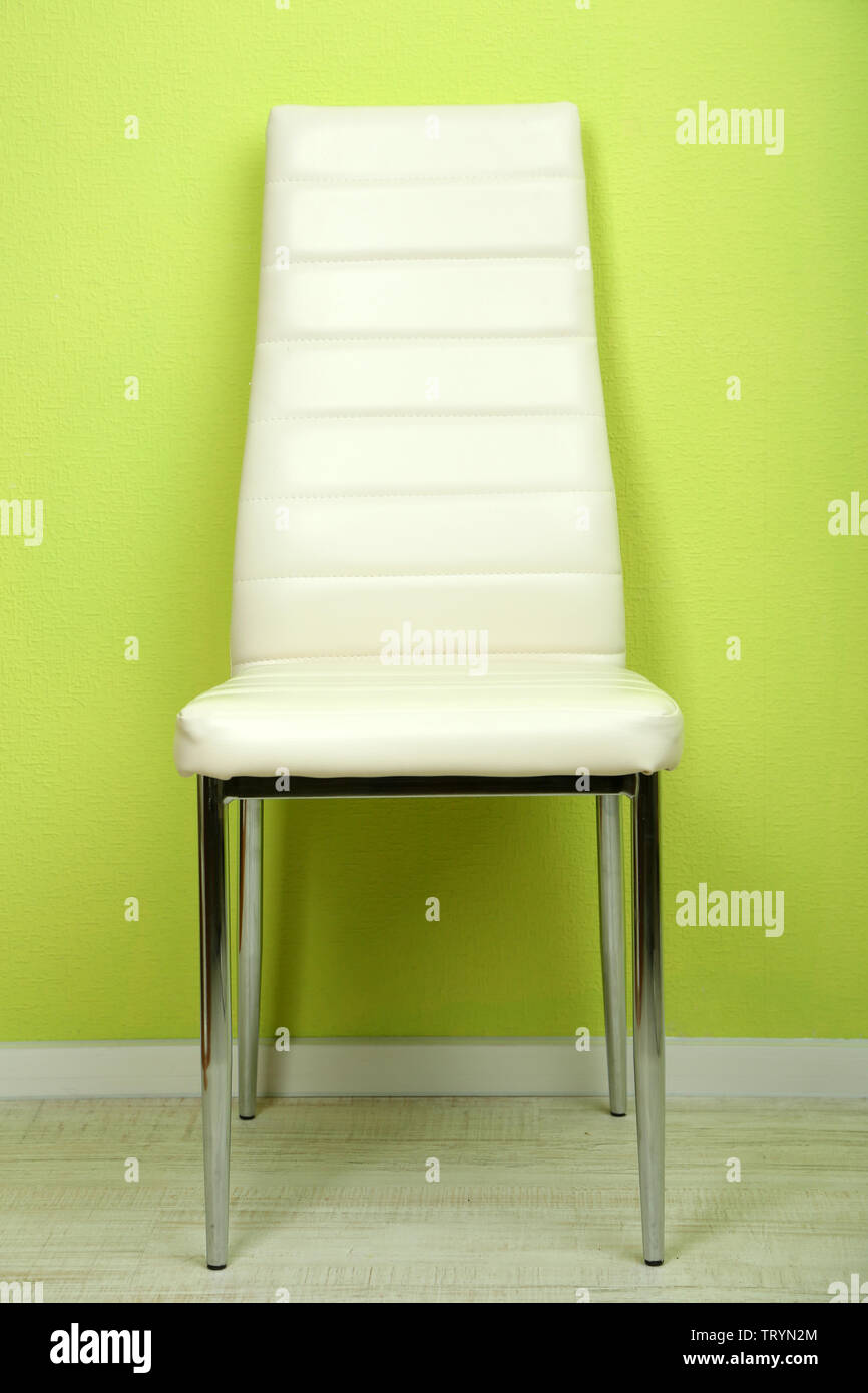 Modern color chair in empty room on wall background Stock Photo - Alamy
