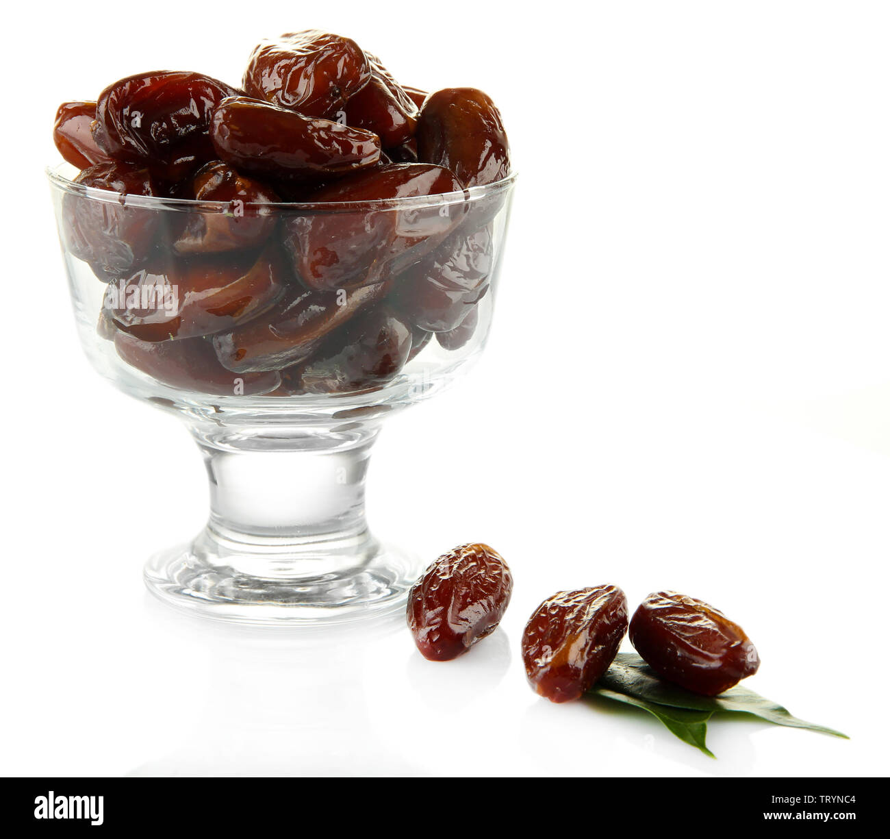 Dried dates in glass bowl isolated on white Stock Photo - Alamy