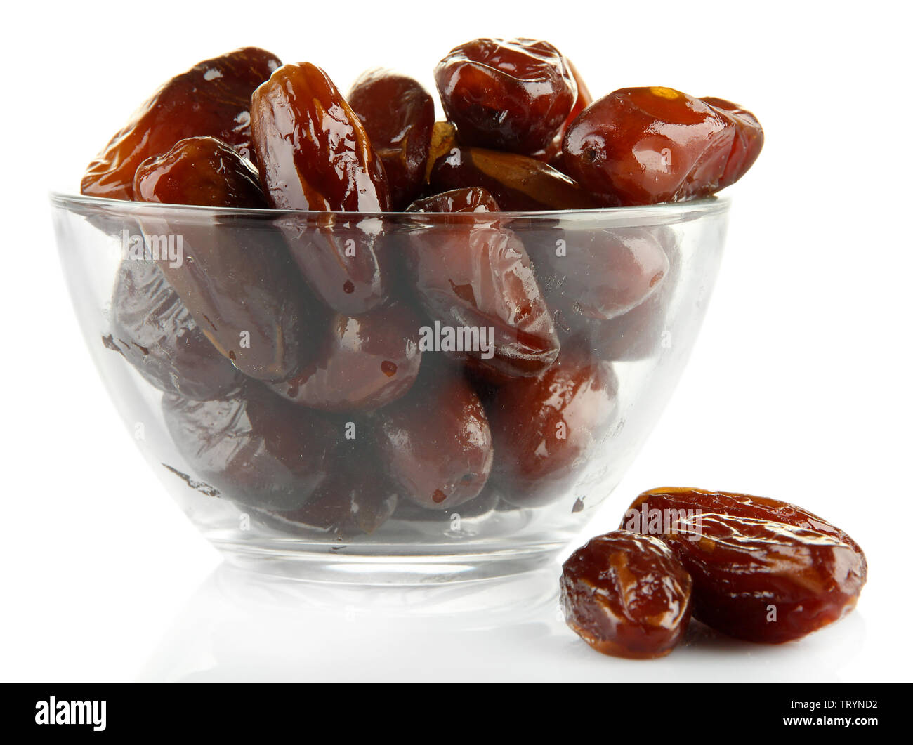 Dried dates in glass bowl isolated on white Stock Photo - Alamy
