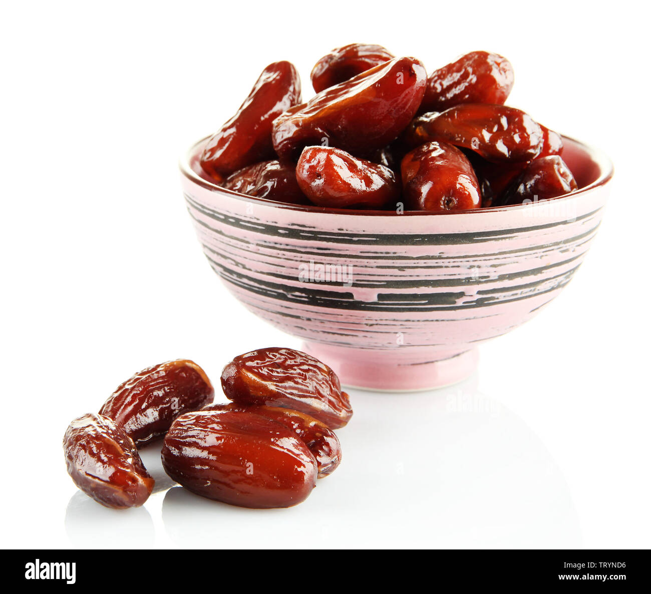 Dried dates in bowl isolated on white Stock Photo - Alamy