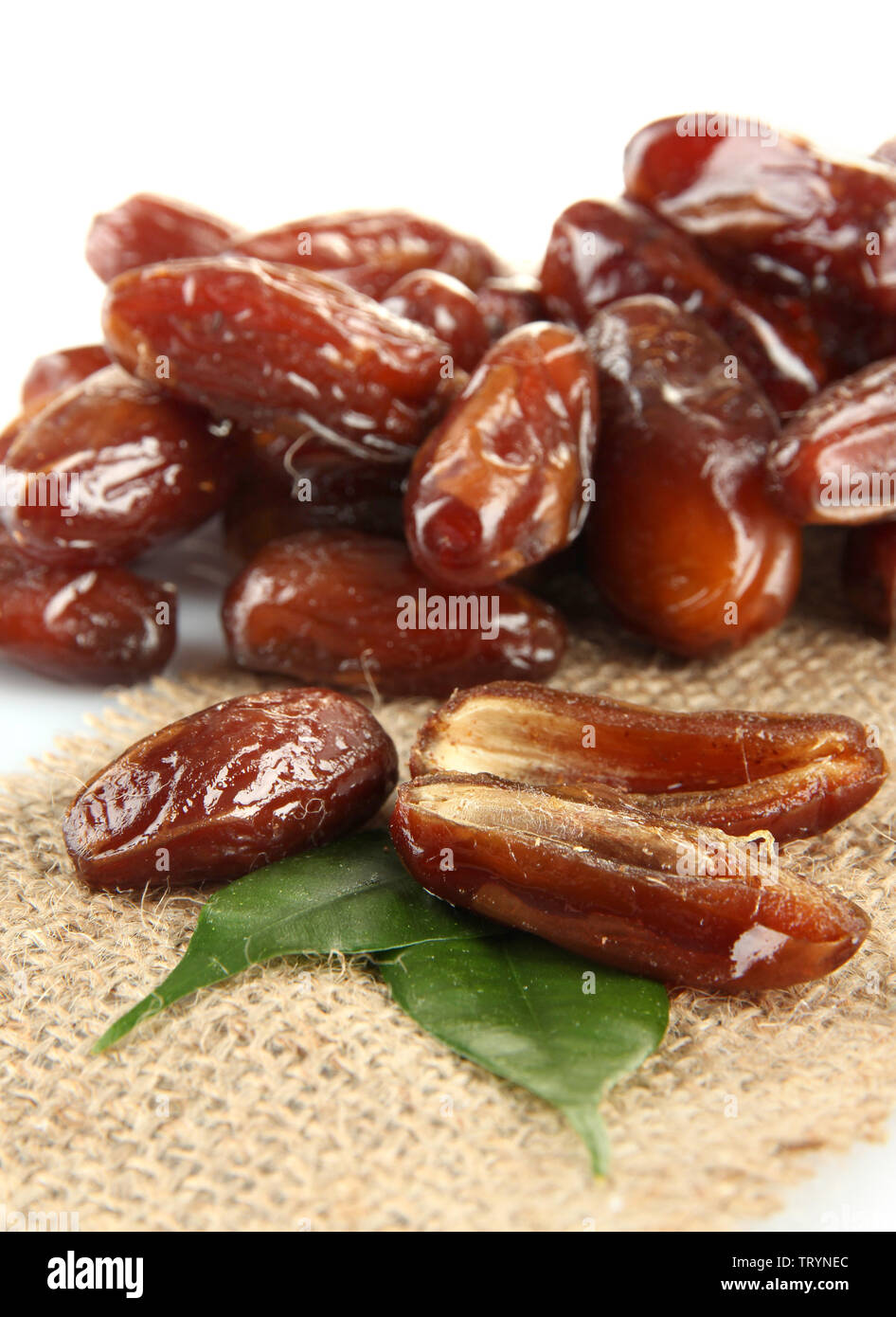 Dried dates on sackcloth isolated on white Stock Photo - Alamy