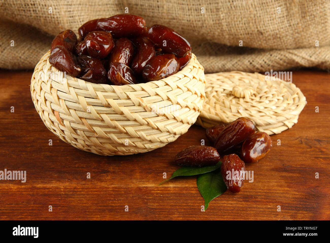 Dried dates in basket on table on sackcloth background Stock Photo - Alamy