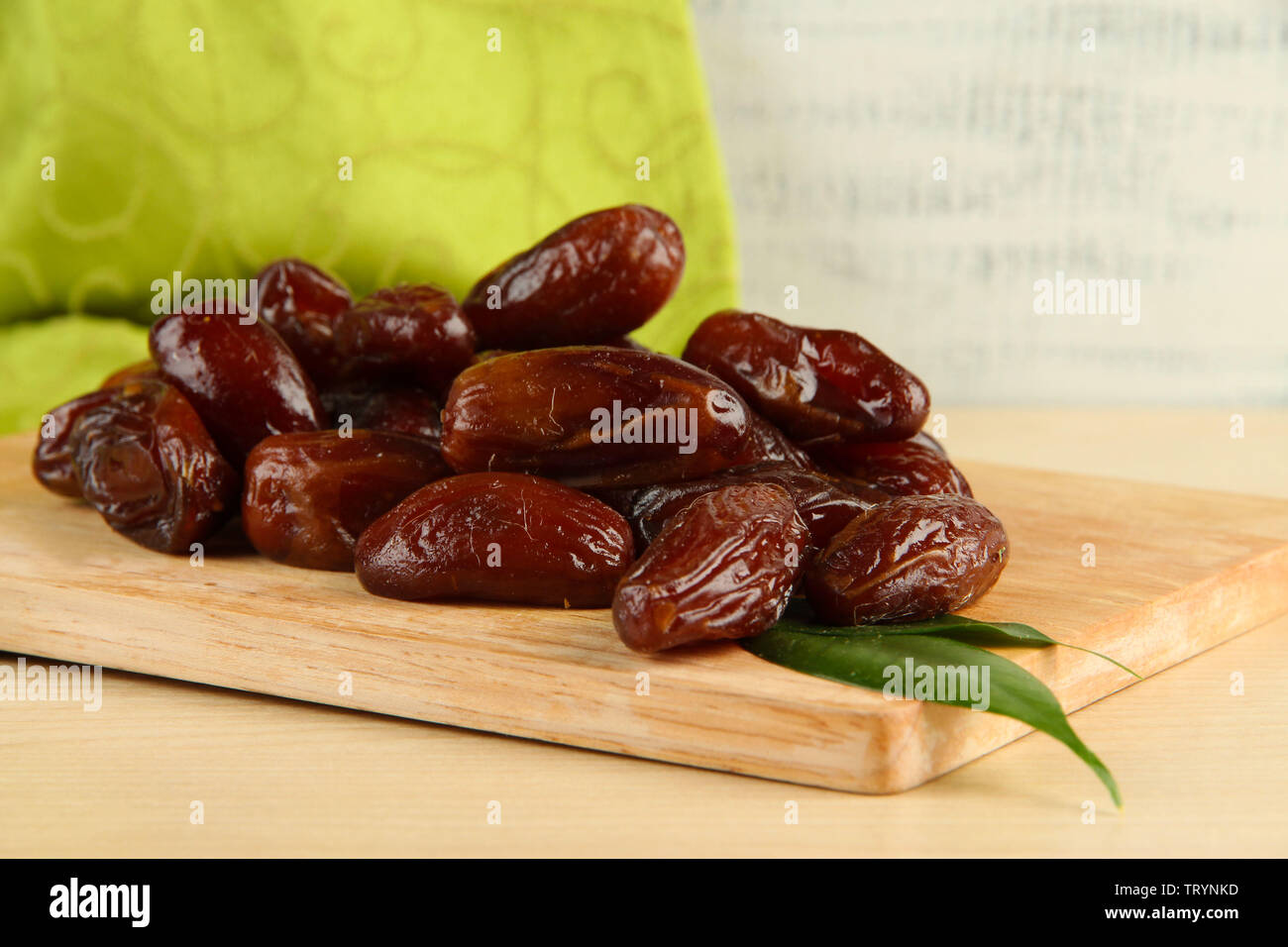 Dried dates on wooden stand on table on fabric background Stock Photo ...