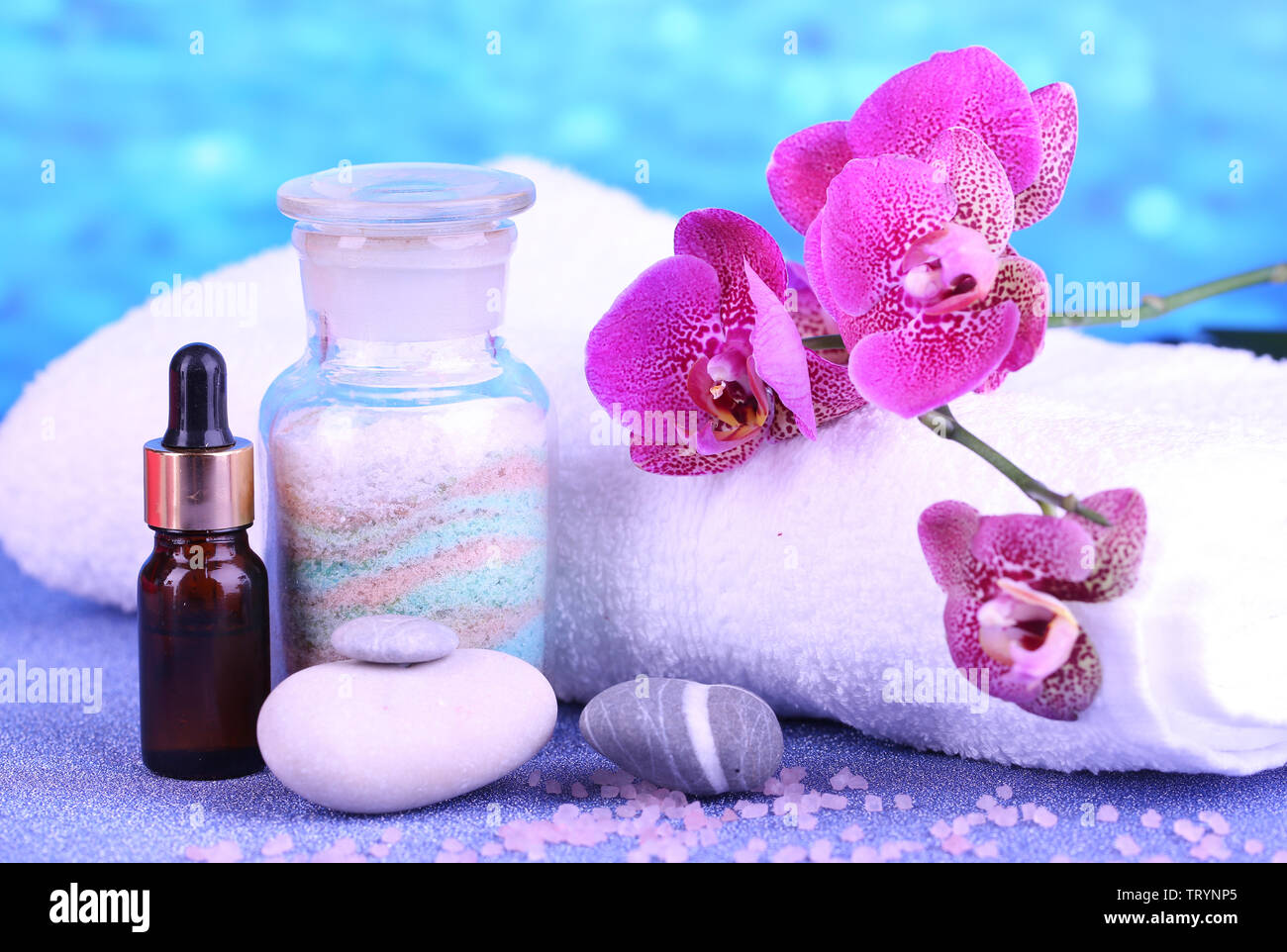 Beautiful spa setting with orchid on blue background Stock Photo - Alamy