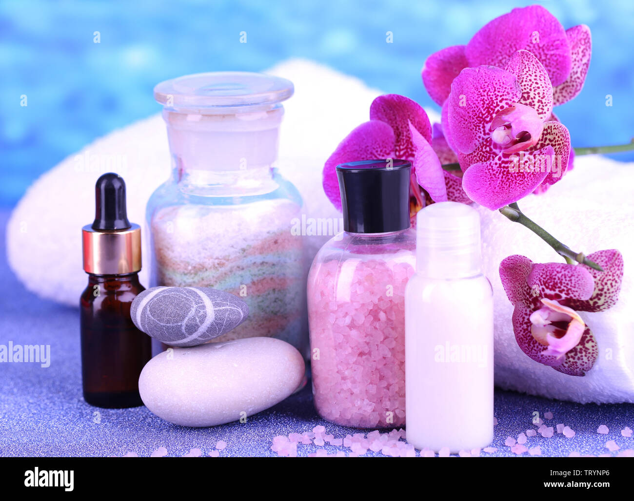 Beautiful spa setting with orchid on blue background Stock Photo - Alamy