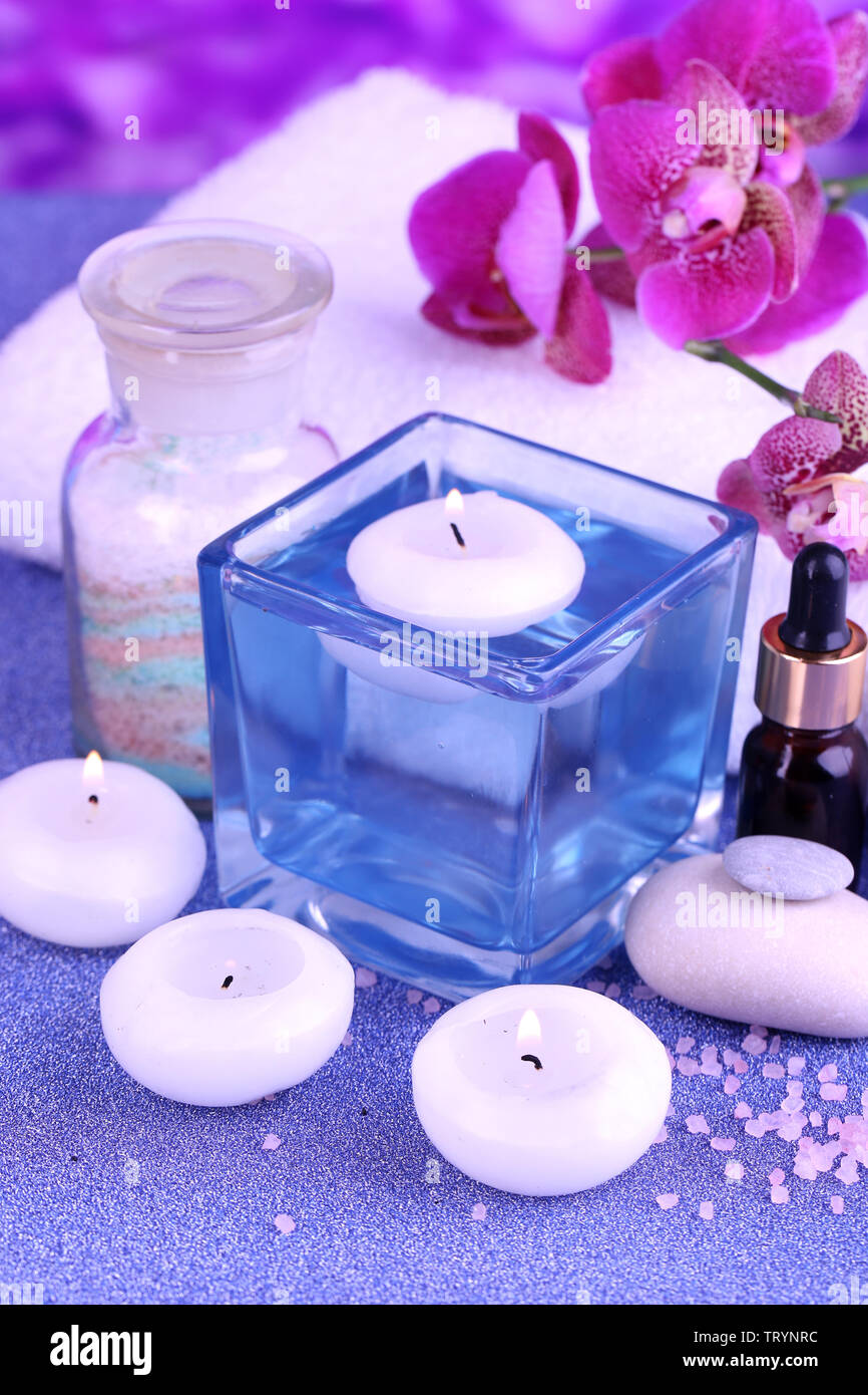 Beautiful spa setting with orchid on purple background Stock Photo - Alamy