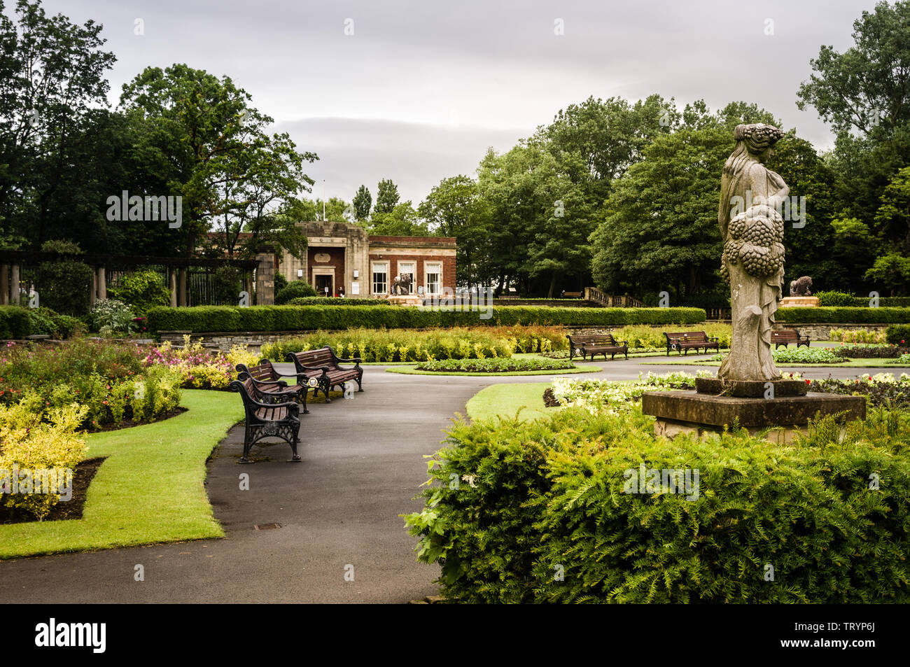 Gardens in Stanley Park Blackpool with trees flowerbeds and bench seats ...