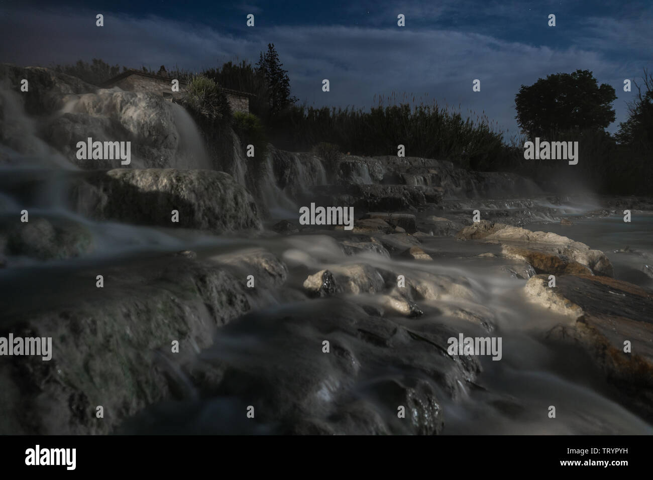 Night view of the famous free spa of the mill in Saturnia in Tuscany ...