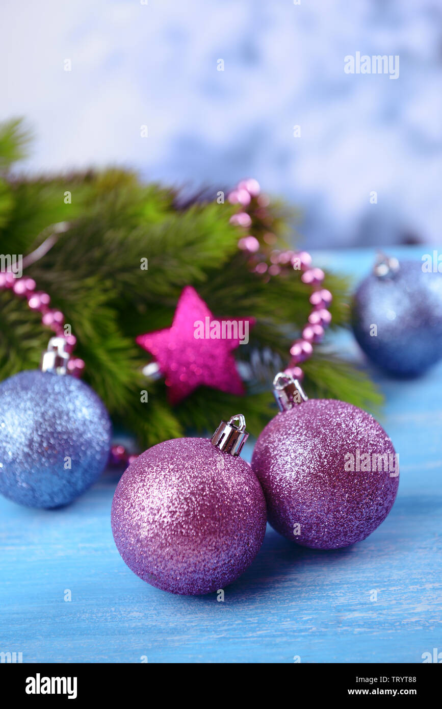 Christmas balls on fir tree, on color background Stock Photo - Alamy