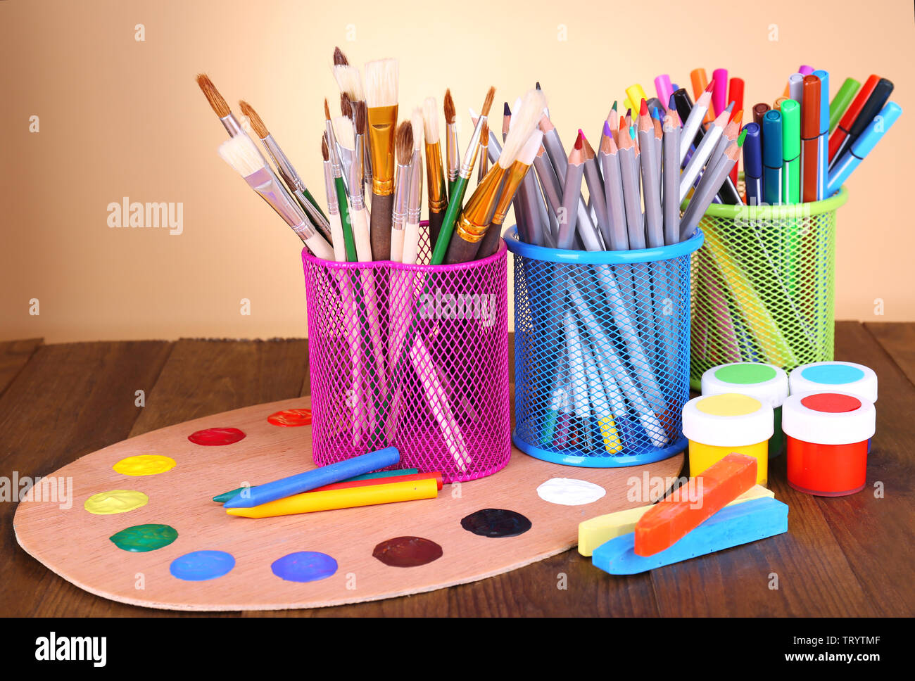 Composition of various creative tools on table on beige background ...