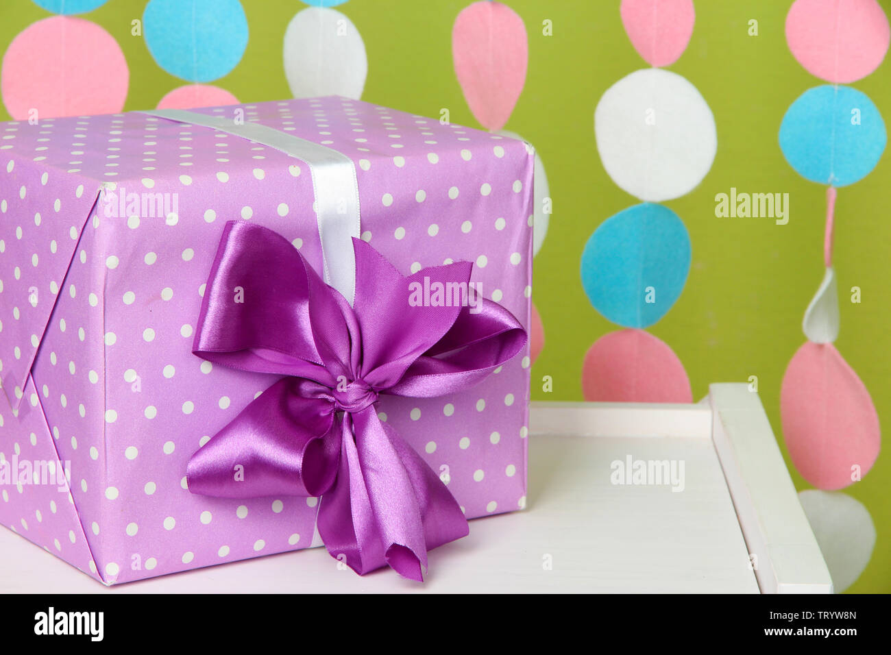 Beautiful present on table on bright background Stock Photo - Alamy