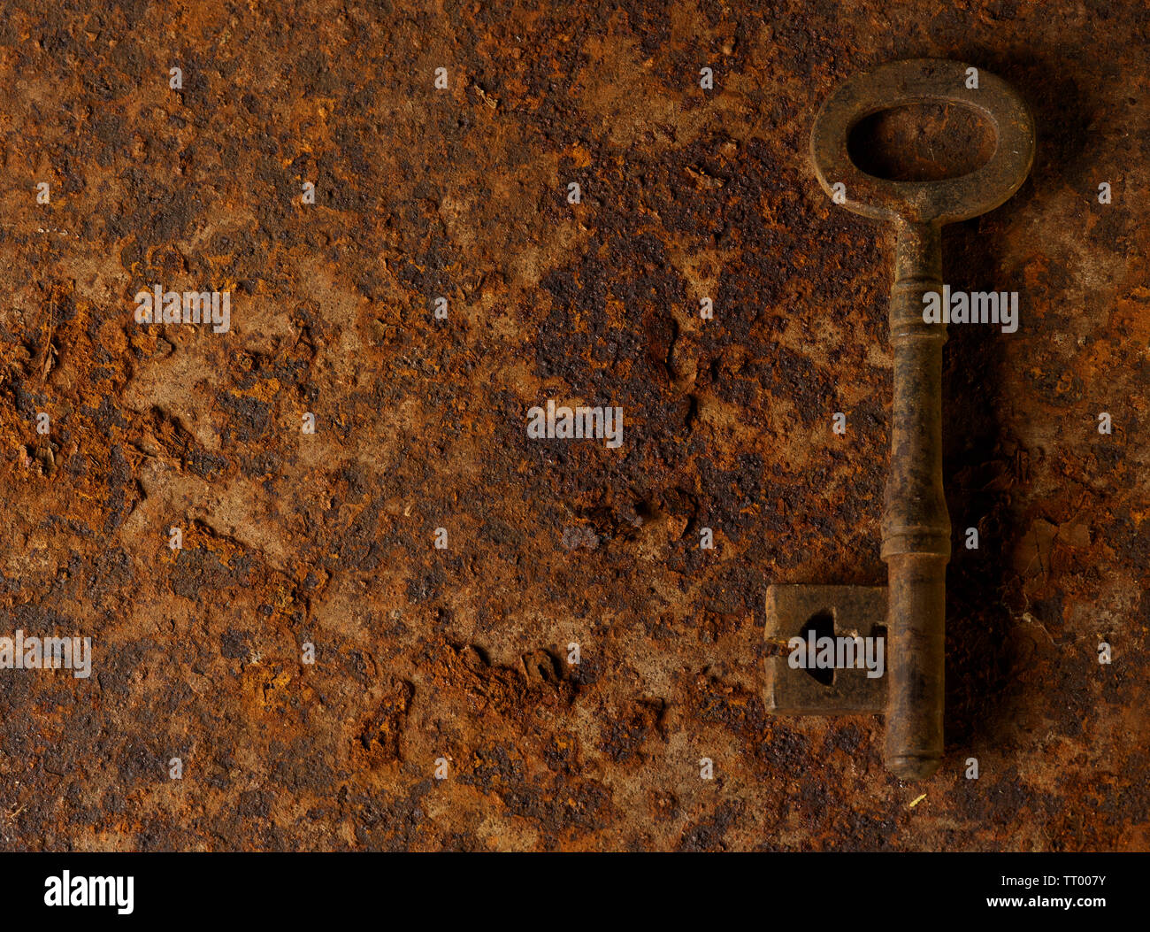 rusty key on a rust background Stock Photo - Alamy