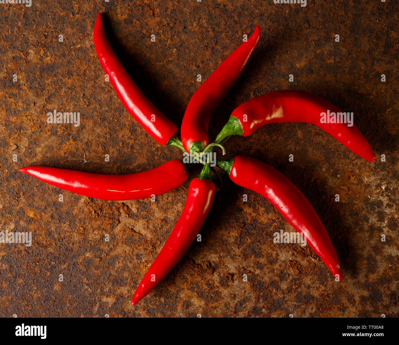 red chillie peppers on a rusty background Stock Photo - Alamy