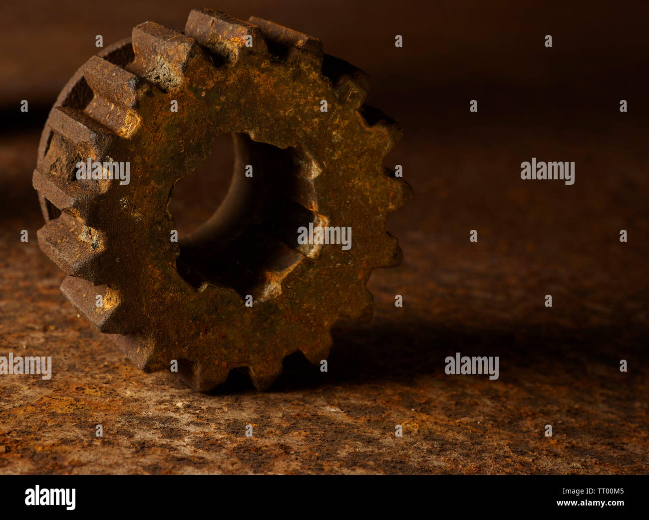 Rusty cog on a rusty background Stock Photo - Alamy