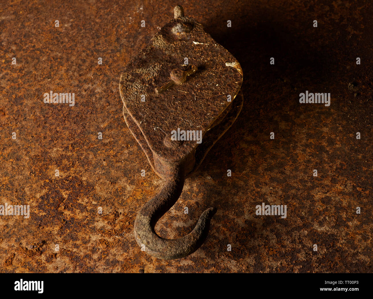 Rusty hook on a rust background Stock Photo - Alamy
