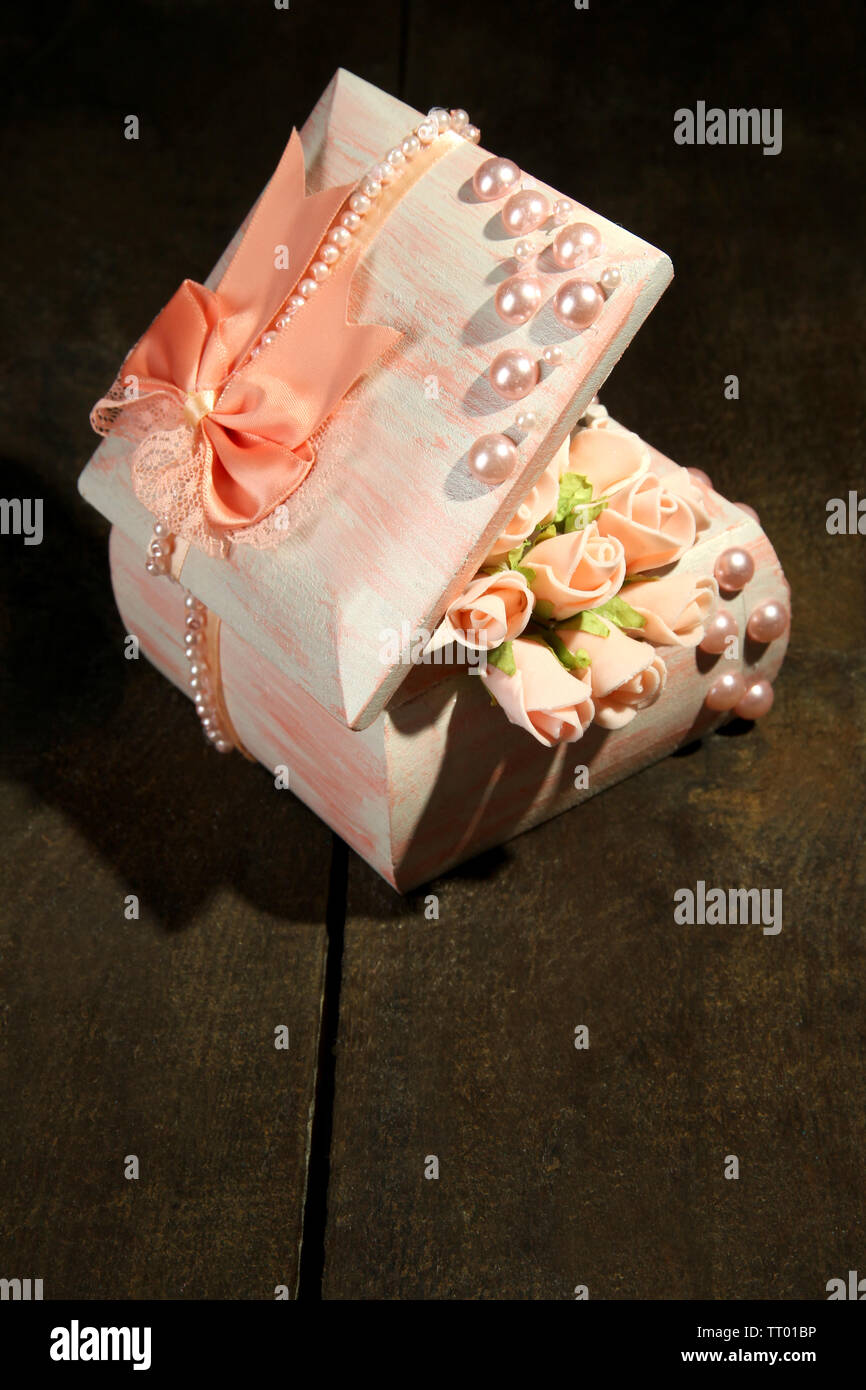 Beautiful hand made casket with roses, on wooden background Stock Photo ...