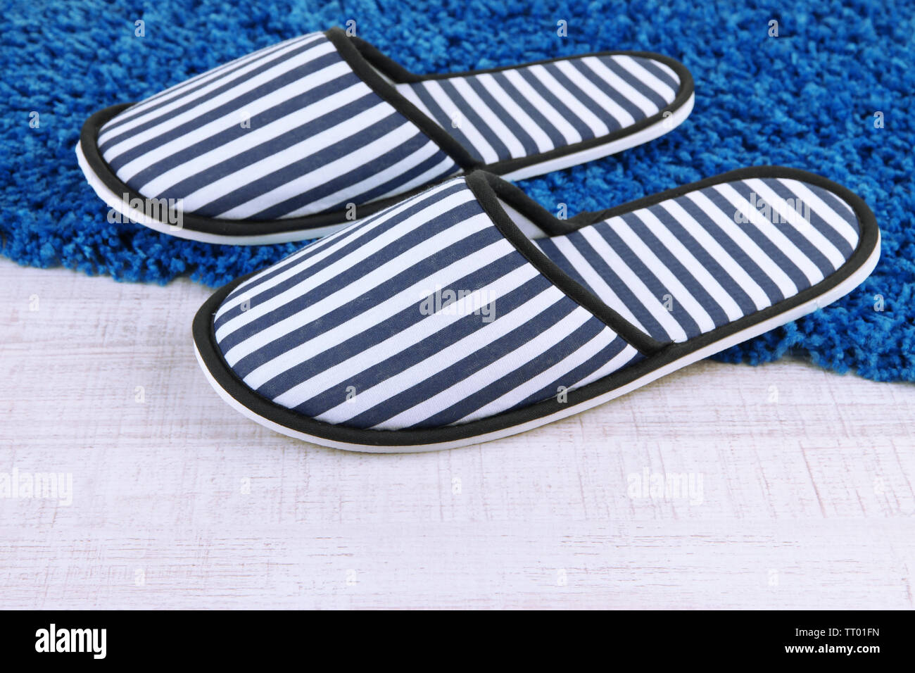 Striped slippers on floor background Stock Photo - Alamy