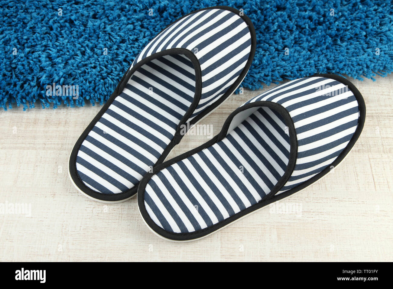 Striped slippers on floor background Stock Photo - Alamy