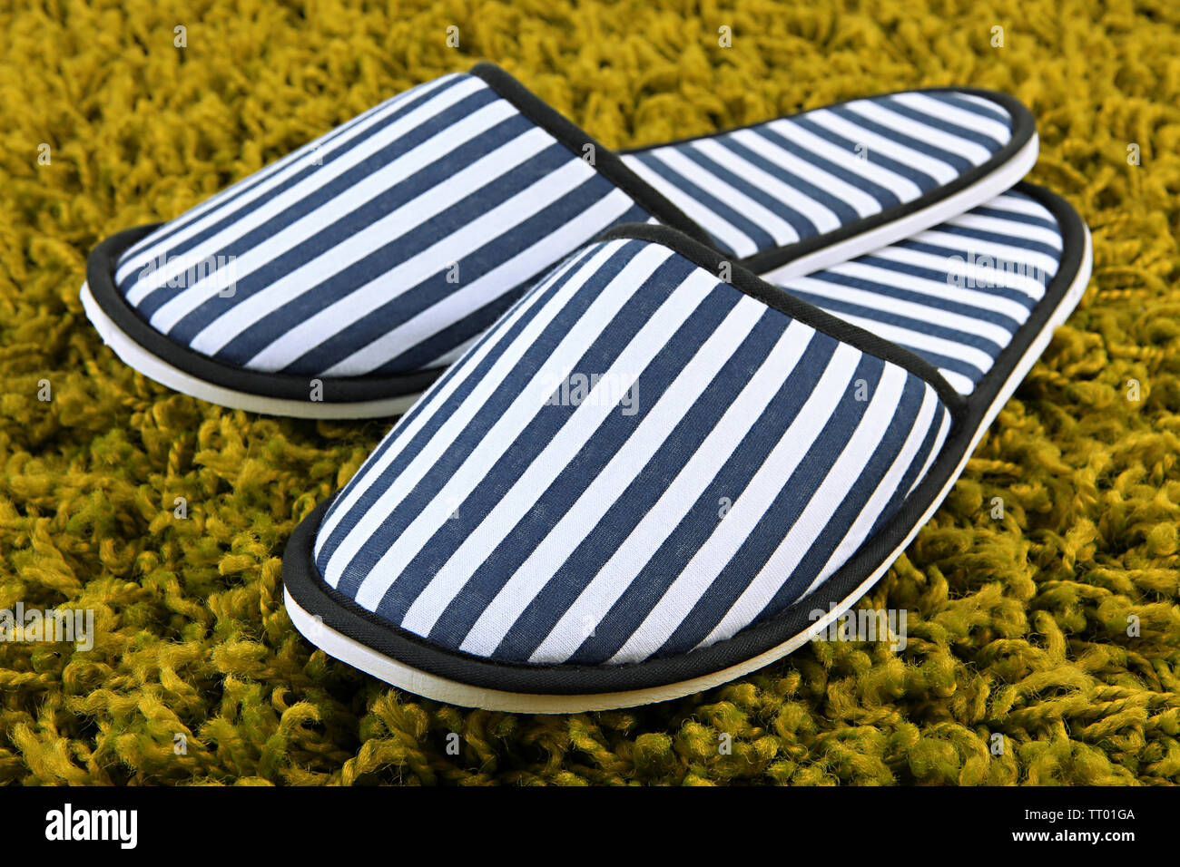 Striped slippers on carpet background Stock Photo - Alamy