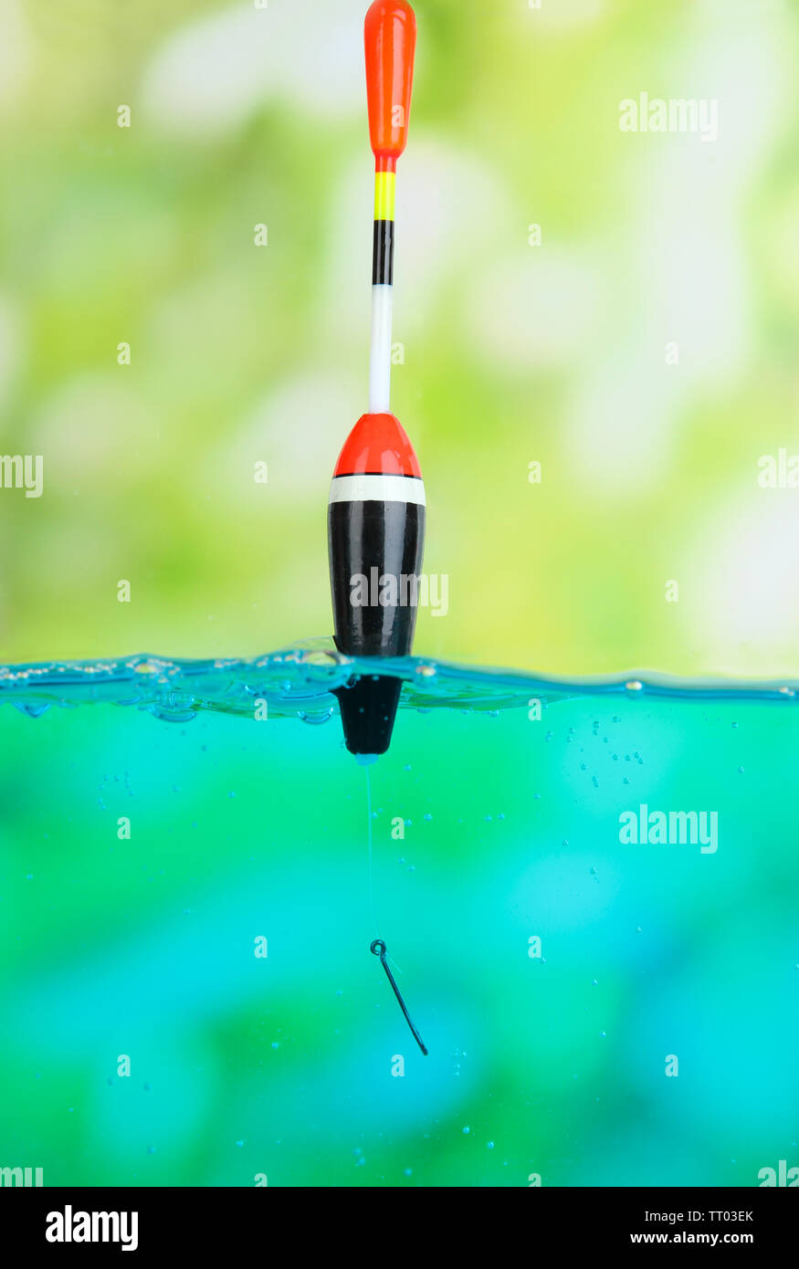 Fishing float in water on natural background Stock Photo - Alamy