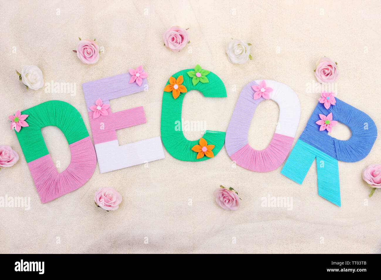 Word Decor created with brightly colored knitting yard on fabric ...